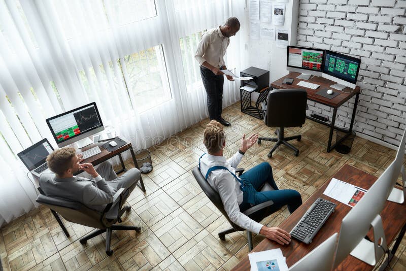 A World of Business. High-angle View of Three Traders Having Chat while ...