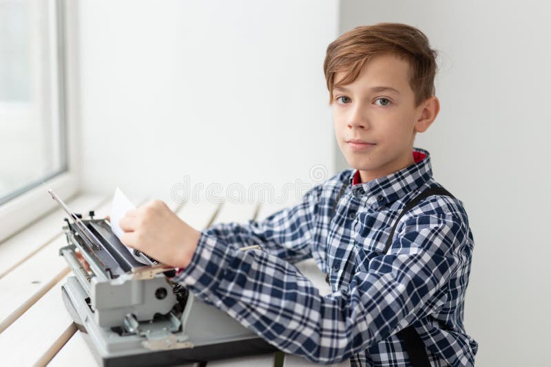 World Day of the Writer Concept - Boy with an Old Typewriter Stock ...