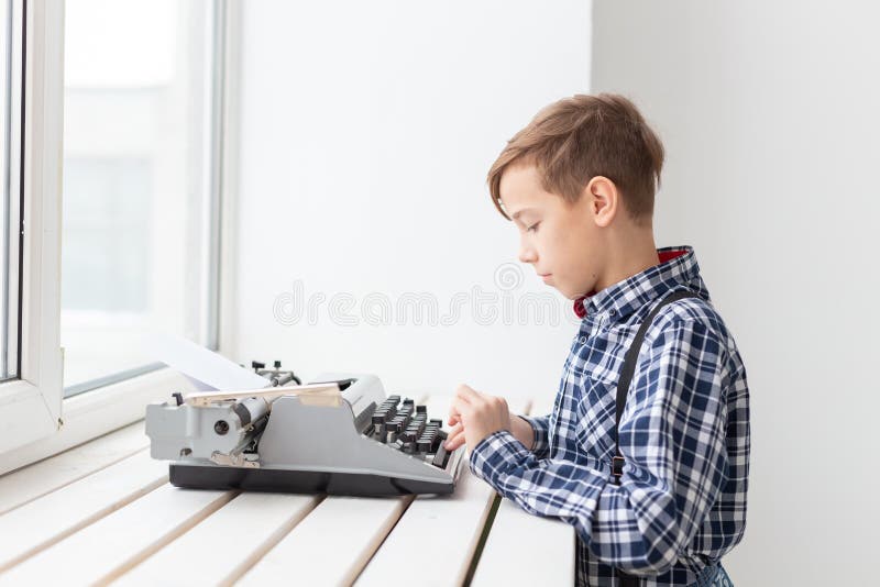 World Day of the Writer Concept - Boy with an Old Typewriter Over ...