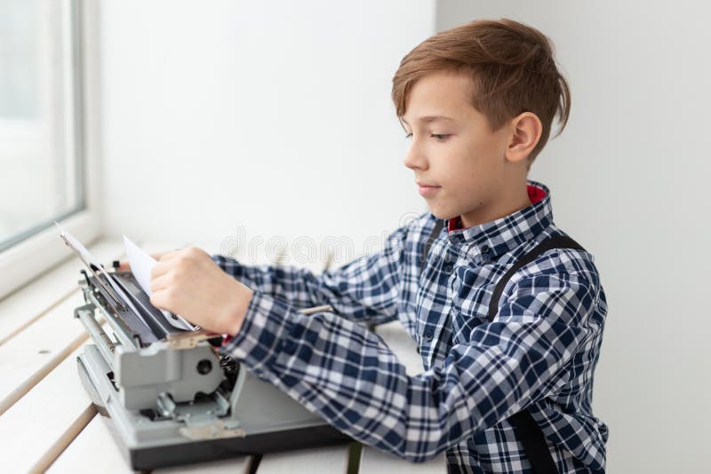 World Day of the Writer Concept - Boy with an Old Typewriter Over ...