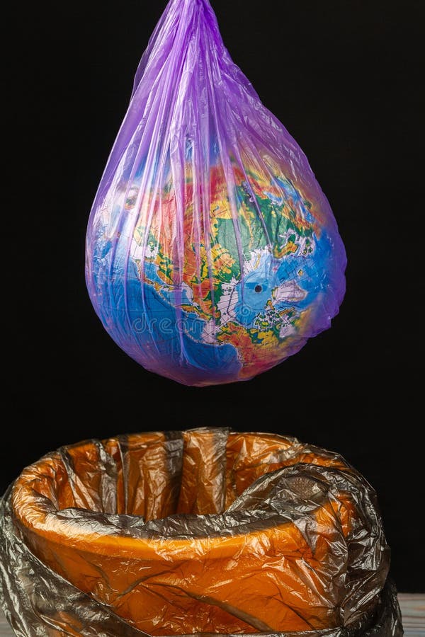 World Globe in Plastic Bag Hanging Over the Rubbish Bin. Stock Image ...