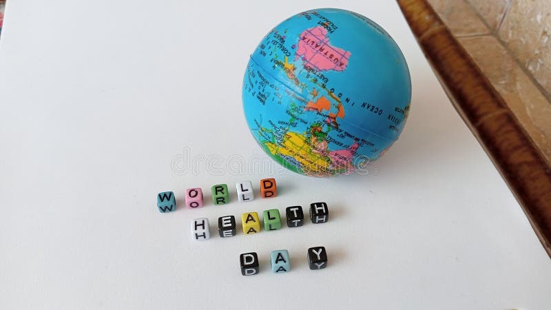 World Health Day Word Made with Plastic Blocks and Blue Mini Globe ...