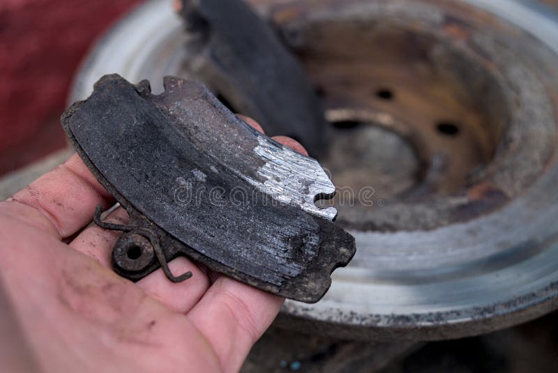 Worn brake pad in hand stock photo. Image of auto, rusty - 358179638