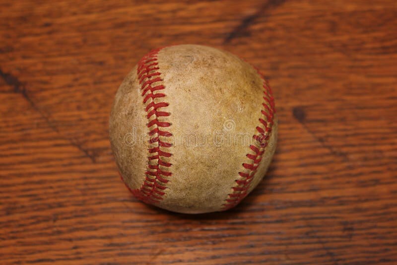 Worn out baseball on wood stock image. Image of shot - 52030757