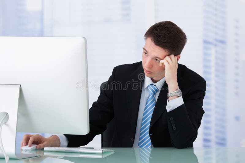 Worried Businessman Looking at Computer at Desk Stock Image - Image of ...