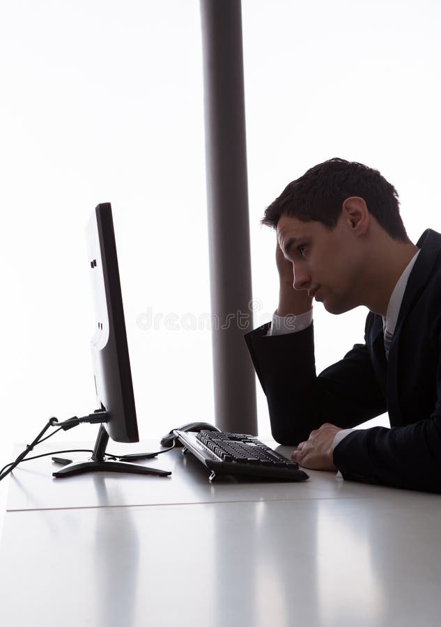 Worried Businessman Looking at Computer at Desk Stock Image - Image of ...