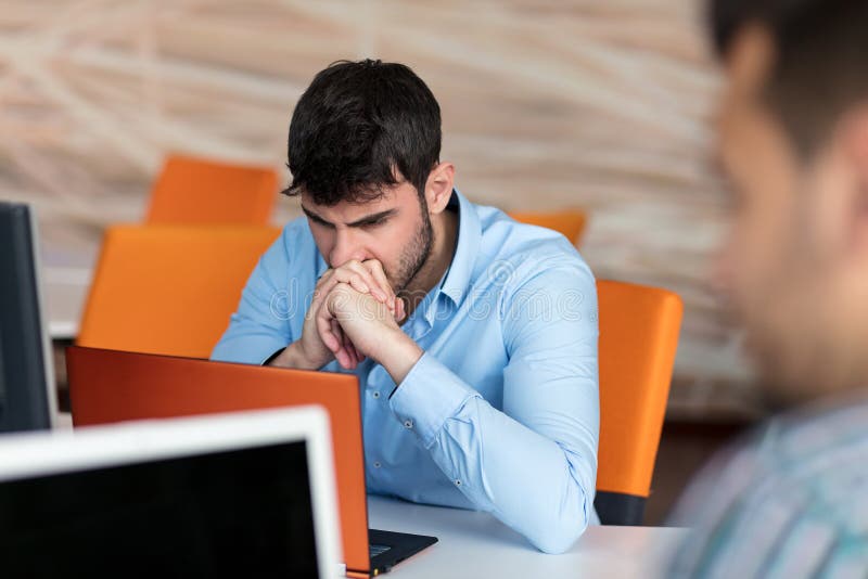 Worried Businessman Working at His Desk in His Office Stock Photo ...