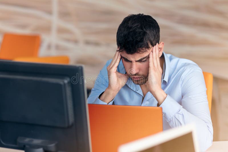 Worried Businessman Working at His Desk in His Office Stock Photo ...