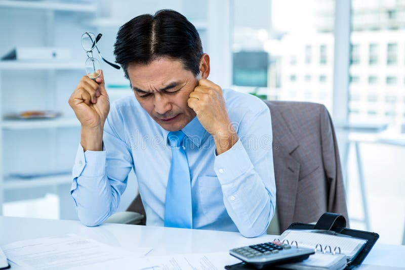 Worried Businessman Working at His Desk Stock Photo - Image of career ...