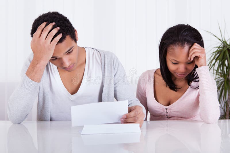 Worried Couple Looking at Paper Stock Photo - Image of document, home ...