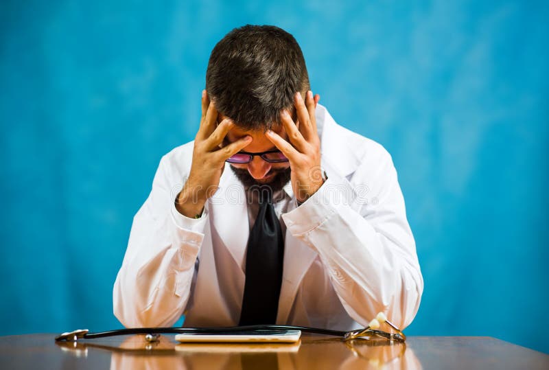 Worried Doctor Showing Concern on the Table Stock Photo - Image of loss ...