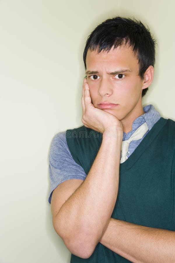 Worried looking young man stock image. Image of leaning - 5621593