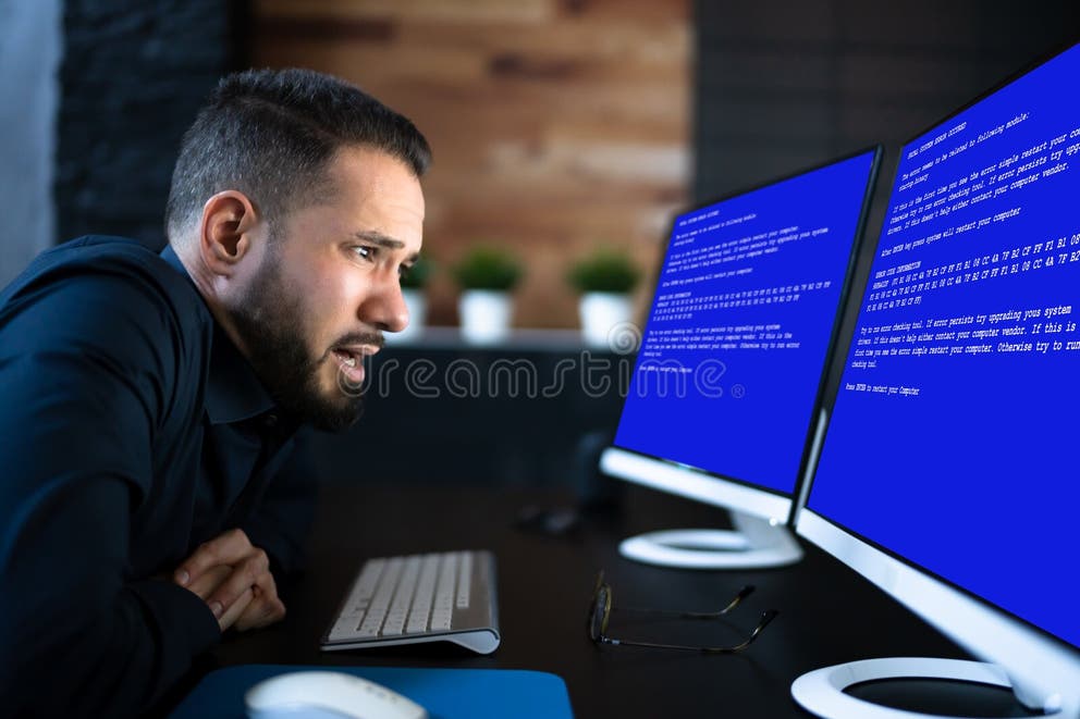 Worried Man at Computer with System Failure Screen Stock Photo - Image ...
