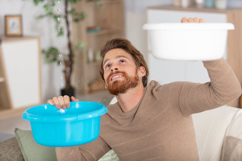 Worried Man Having Leakage Water Falling into Bucket at Home Stock ...