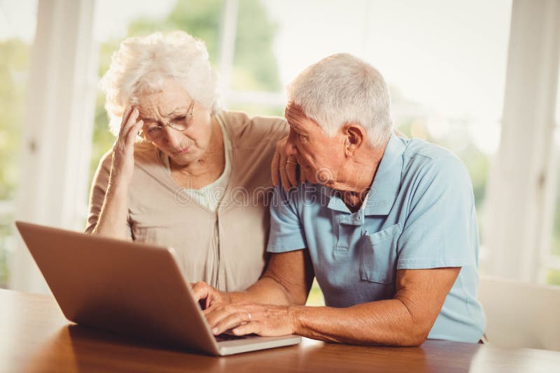 Worried Senior Couple Using Laptop Stock Photo - Image of people, house ...