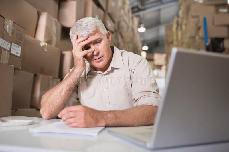 Worried Warehouse Manager with Laptop Stock Image - Image of male, desk ...