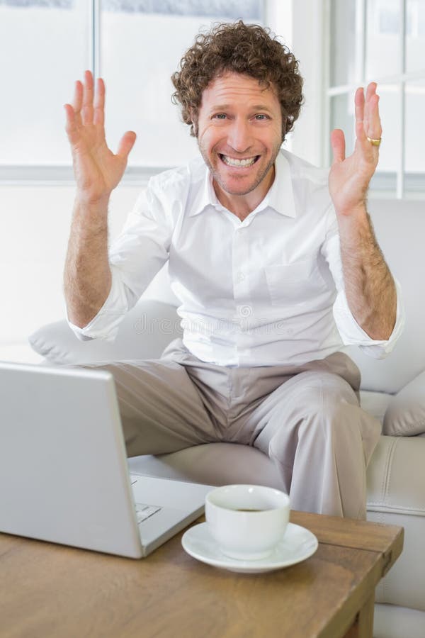 Worried Well Dressed Man Sitting with Head in Hands on Sofa in the ... Worried Well Dressed Man Sitting with Head in Hands on Sofa in the ...