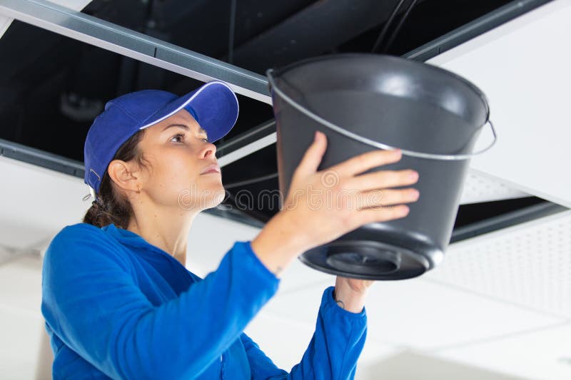 Worried Woman Holding Bucket from Ceiling in Kitchen Stock Image ...