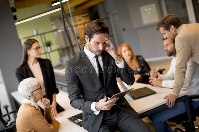 Worried Young Businessman Using Digital Tablet in Office Stock Image ...