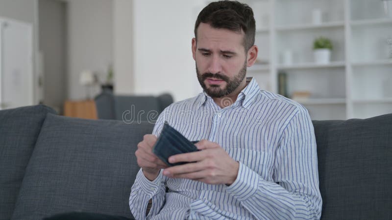Worried Young Man Checking Empty Pocket for Money at Home Stock Photo ...