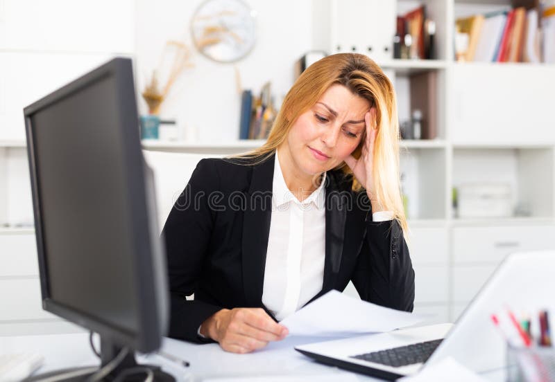 Worried Young Woman Manager Working at Laptop with Documents Stock ...