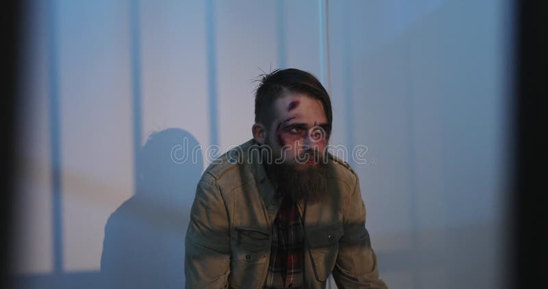 A Wounded Man with a Beard Sleeps Behind a Prison Grate. Stock Video ...