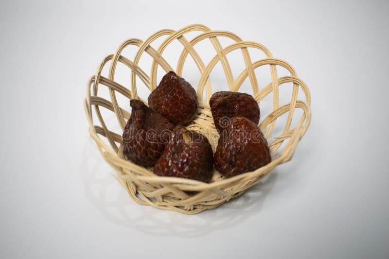 A Woven Basket Containing Kelubi Fruit is Placed on a White Background ...