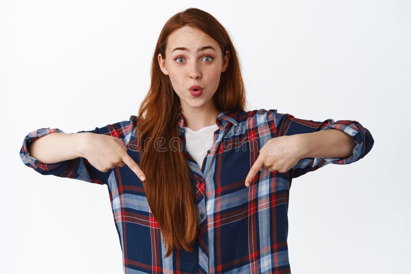 Wow Check it Out. Surprised and Curious Ginger Girl Pointing Down ...