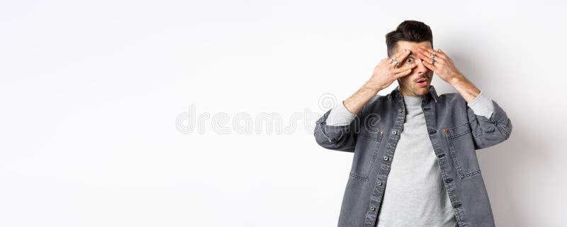 Wow Interesting. Curious Guy Peeking through Fingers at Camera, Looking ...