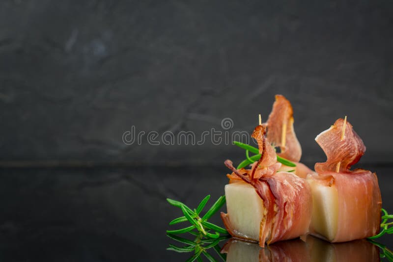 Wrap a Slice of Parma Ham Around Each Piece of Melon.Â Stock Photo ...