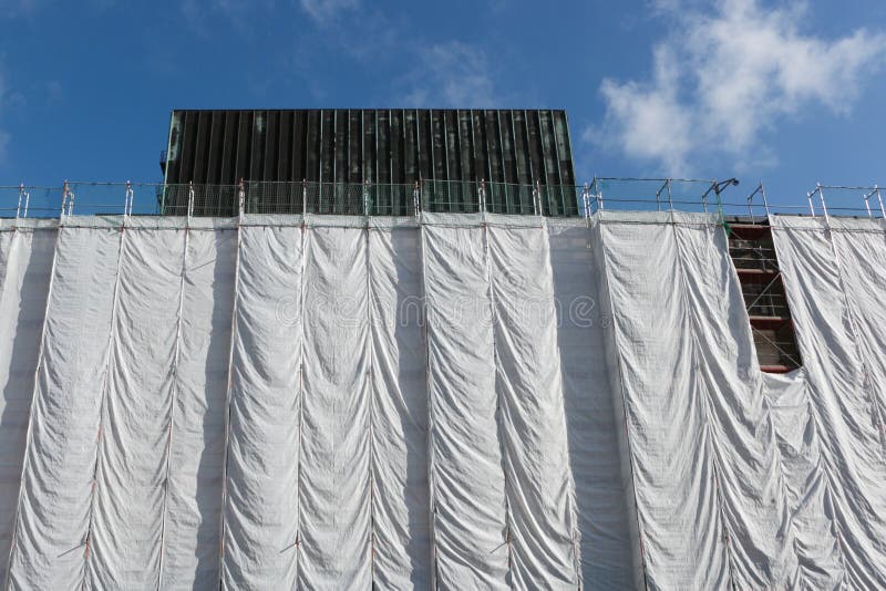 Scaffolding with Canvas Covers on Construction Site Residential ...