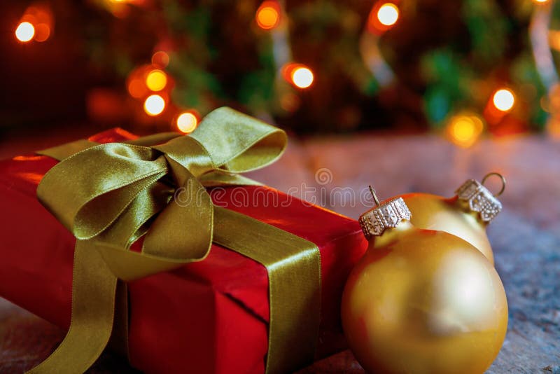 Wrapped Gift on the Background of Christmas Lights Stock Photo - Image ...