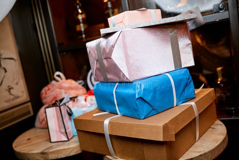 Wrapped Gifts of Different Sizes in Different Colors on the Table Stock ...
