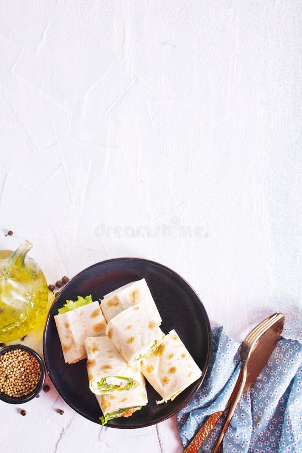 Wrapped Tortilla Sandwich Rolls Cut in Half and Ingredients Stock Image ...
