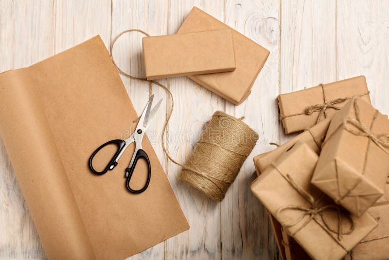 Wrapping Christmas Gifts in Kraft Paper and Rope. Stock Photo - Image ...