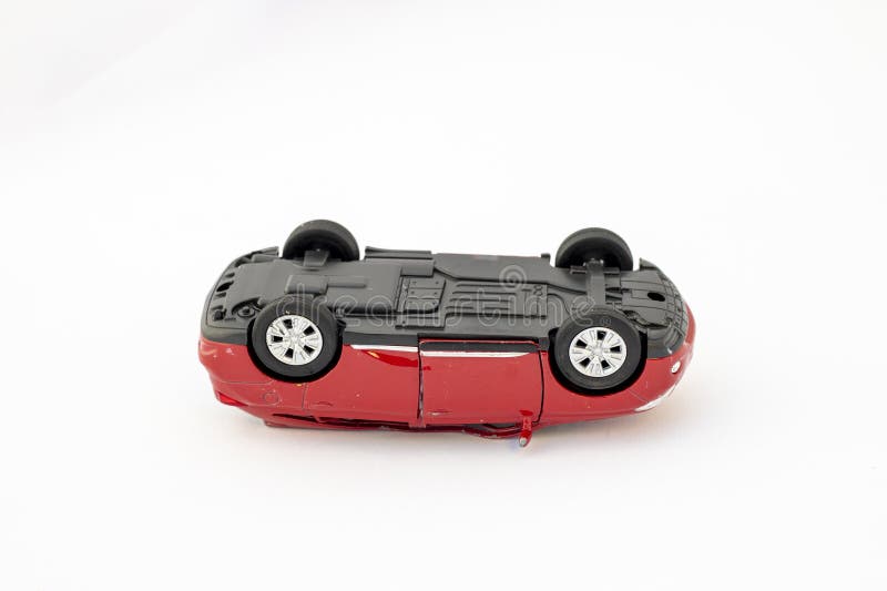 Wreckage of a Toy Red Car Laying Upside Down in a Road Accident Stock ...