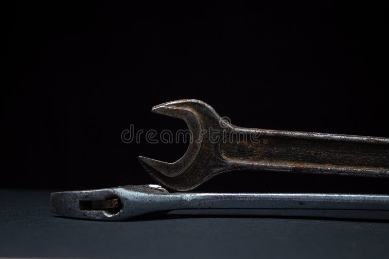 Wrench and Adjustable Wrench on a Black Background. Old Working Tools ...