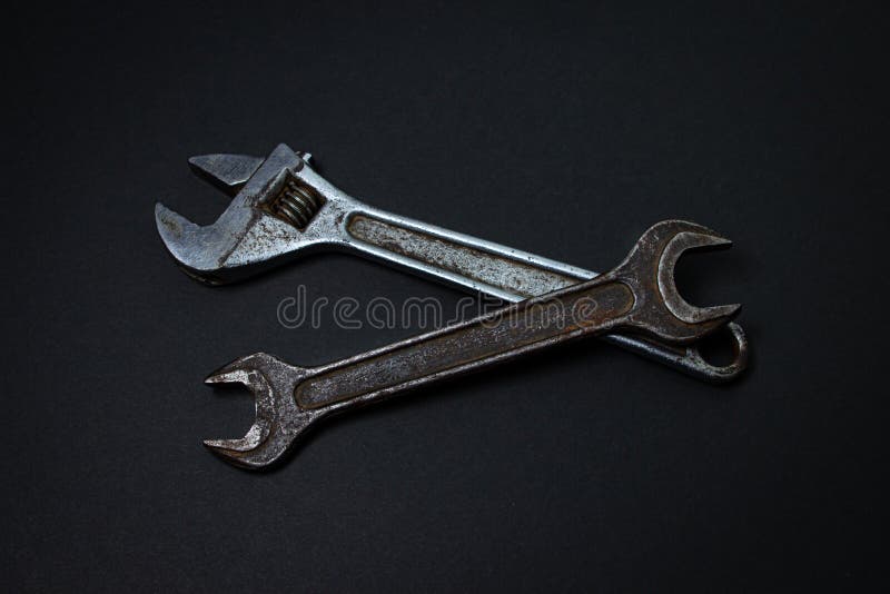 Wrench and Adjustable Wrench on a Black Background. Old Working Tools ...