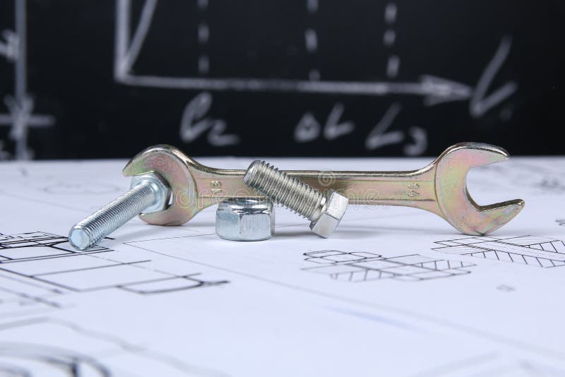 Wrench, Bolts and Nuts on Background of Engineering Drawings. Stock ...