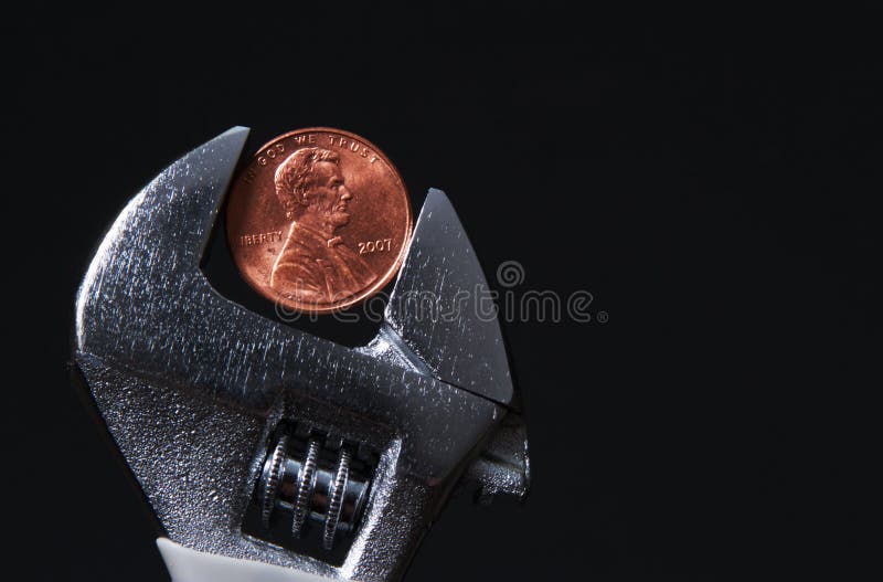 A wrench holding a coin stock image. Image of issues - 108849951