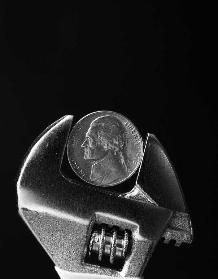 A wrench holding a coin stock photo. Image of hold, issues - 108849964