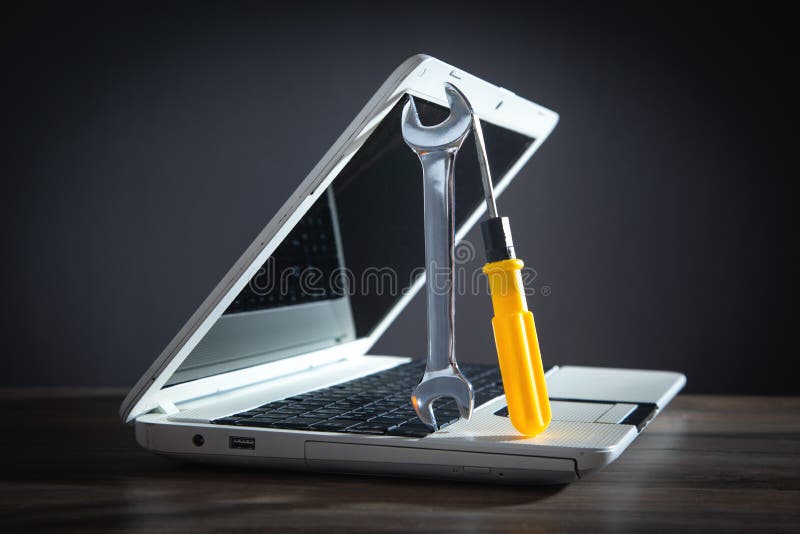 Wrench and Screwdriver with a Laptop Computer. it Service Stock Photo ...
