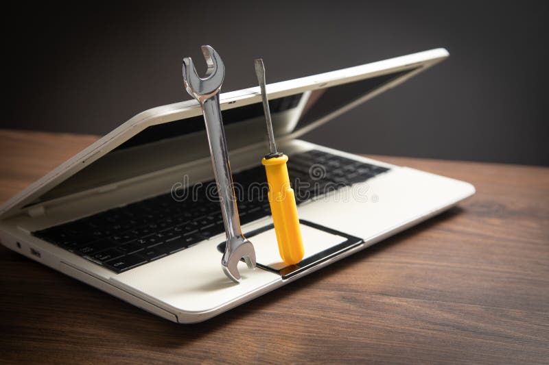 Wrench and Screwdriver with a Laptop Computer. it Service. Support ...