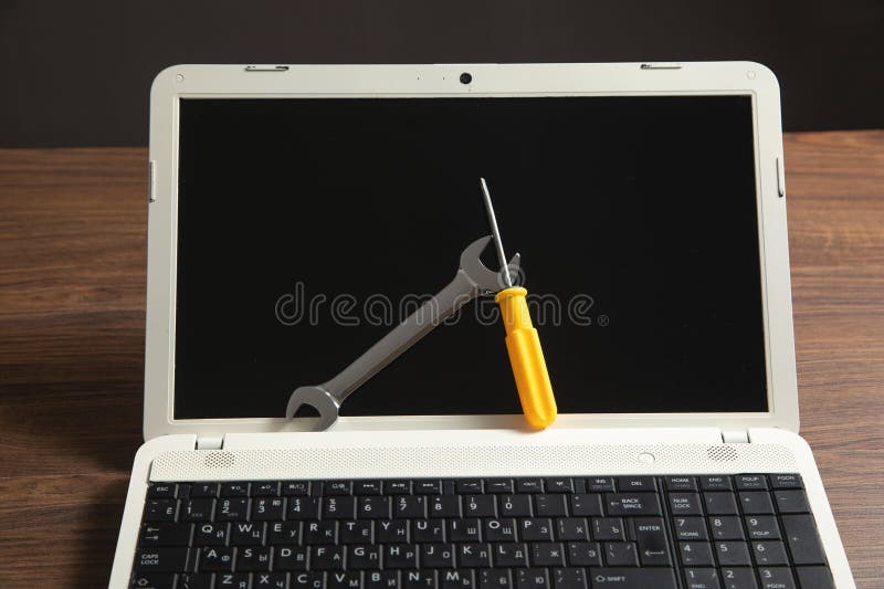 Wrench and Screwdriver with a Laptop Computer. it Service. Support ...