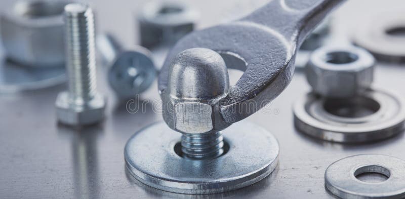 Wrench Tightens Steel Cap Nut in Steel Billet. Spanner, Bolt, and Nuts ...