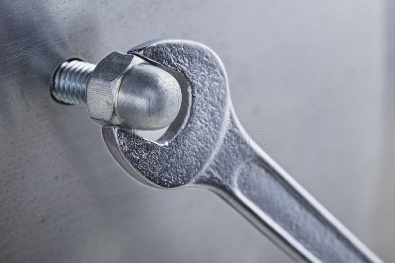 Wrench Tightens Steel Cap Nut in Steel Billet. Spanner, Bolt, and Nuts ...