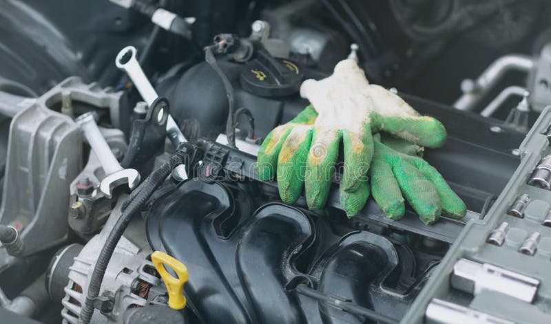 Repair Wrenches and Work Gloves Lie on the Car Engine in the Engine ...