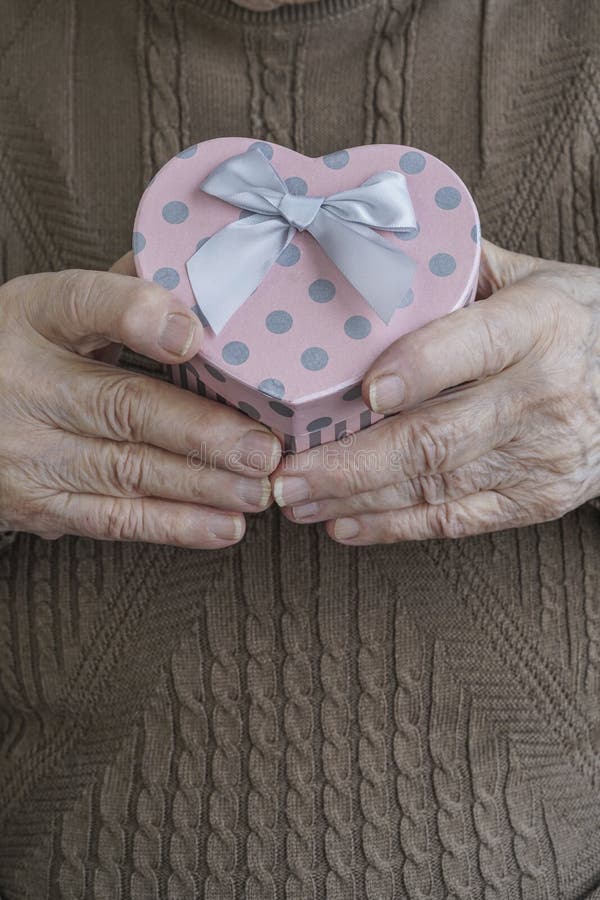 Wrinkled Hands Holding a Heart Shaped Gift Stock Photo - Image of ...