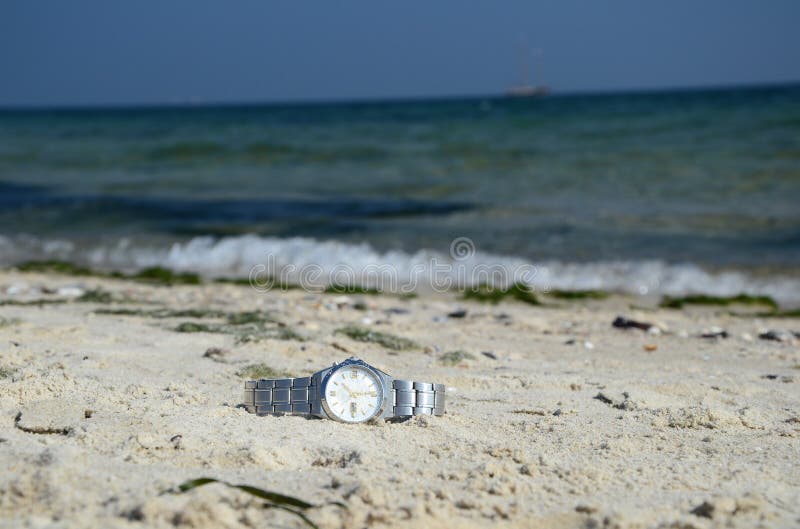 Wrist Watch Lying on the Sand at the Ocean Beach Stock Image - Image of ...