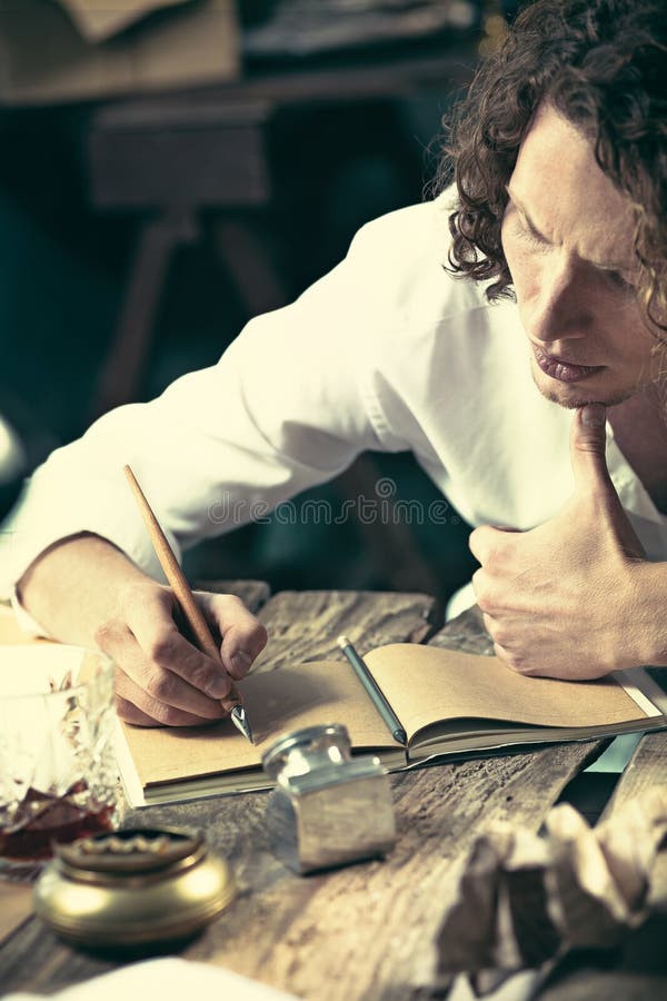 Writer at Work. Handsome Young Writer Sitting at the Table and Writing ...